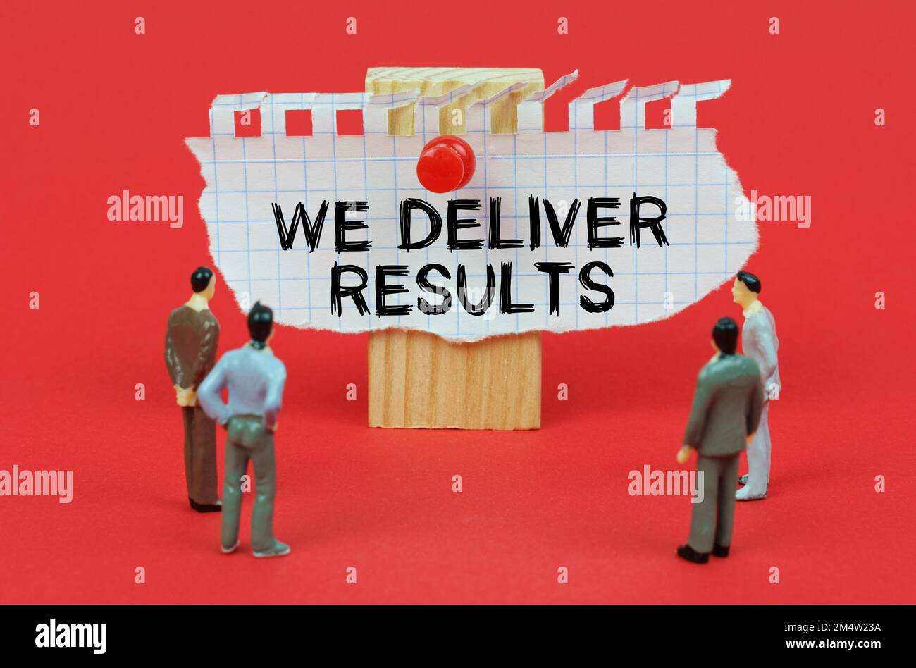 Business concept. On a red background are miniature figures of people ...