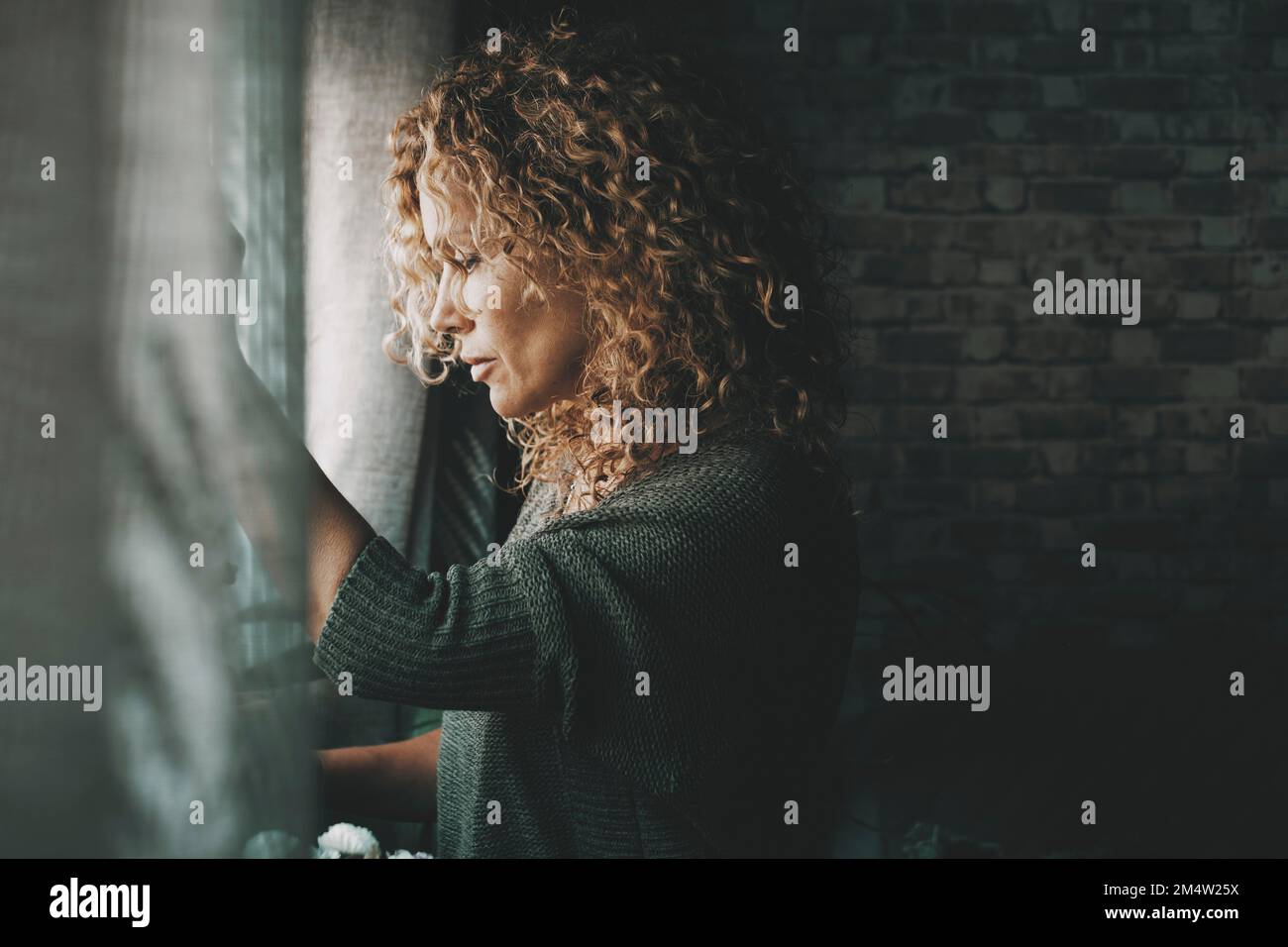 Sadness worried woman inside home near the window. Bad unhappy day ...