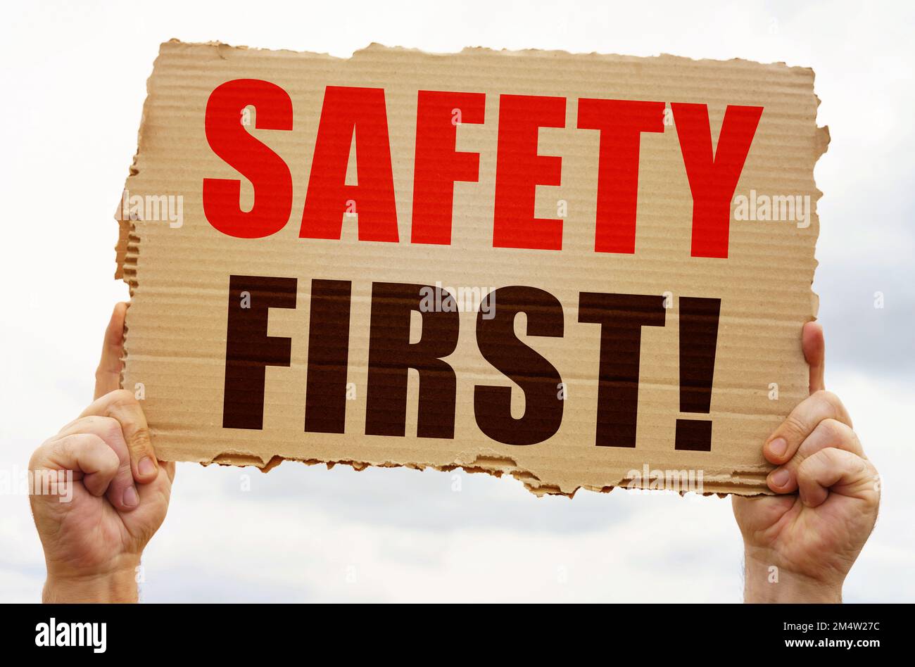 Industrial concept. In the hands of a man is a cardboard sign with the ...