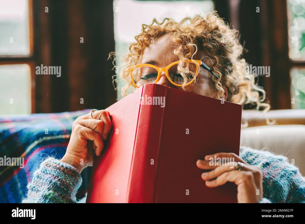 Woman relax and pleasure expression about reading a book novel alone at ...