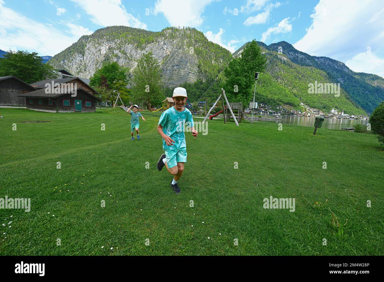 Two brothers running and having fun at Hallstatt, Austria Stock Photo ...