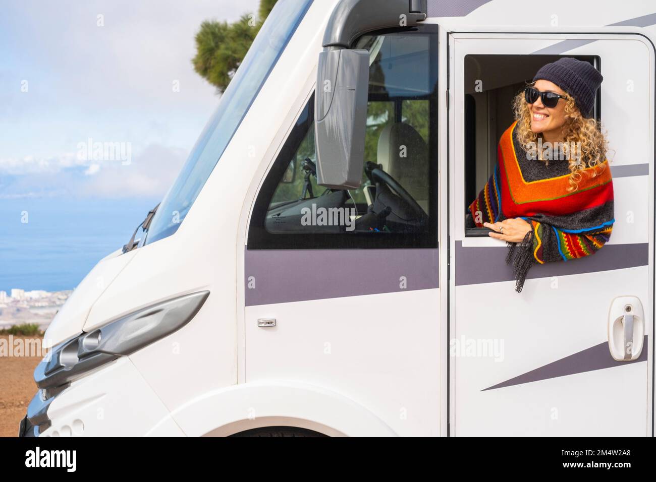 One woman driver outside the window of her modern big camper van ...