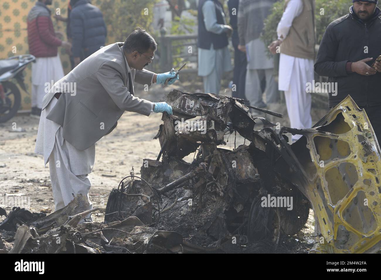 Islamabad. 23rd Dec, 2022. A member of security personnel investigates ...