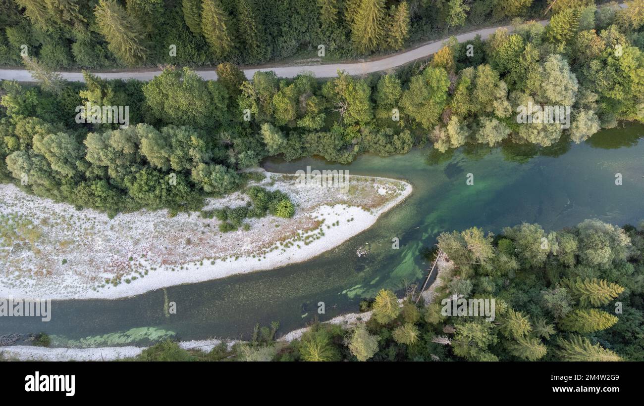 Overhead shot of river Sava Bohinjka near Bled, with a gravel road ...