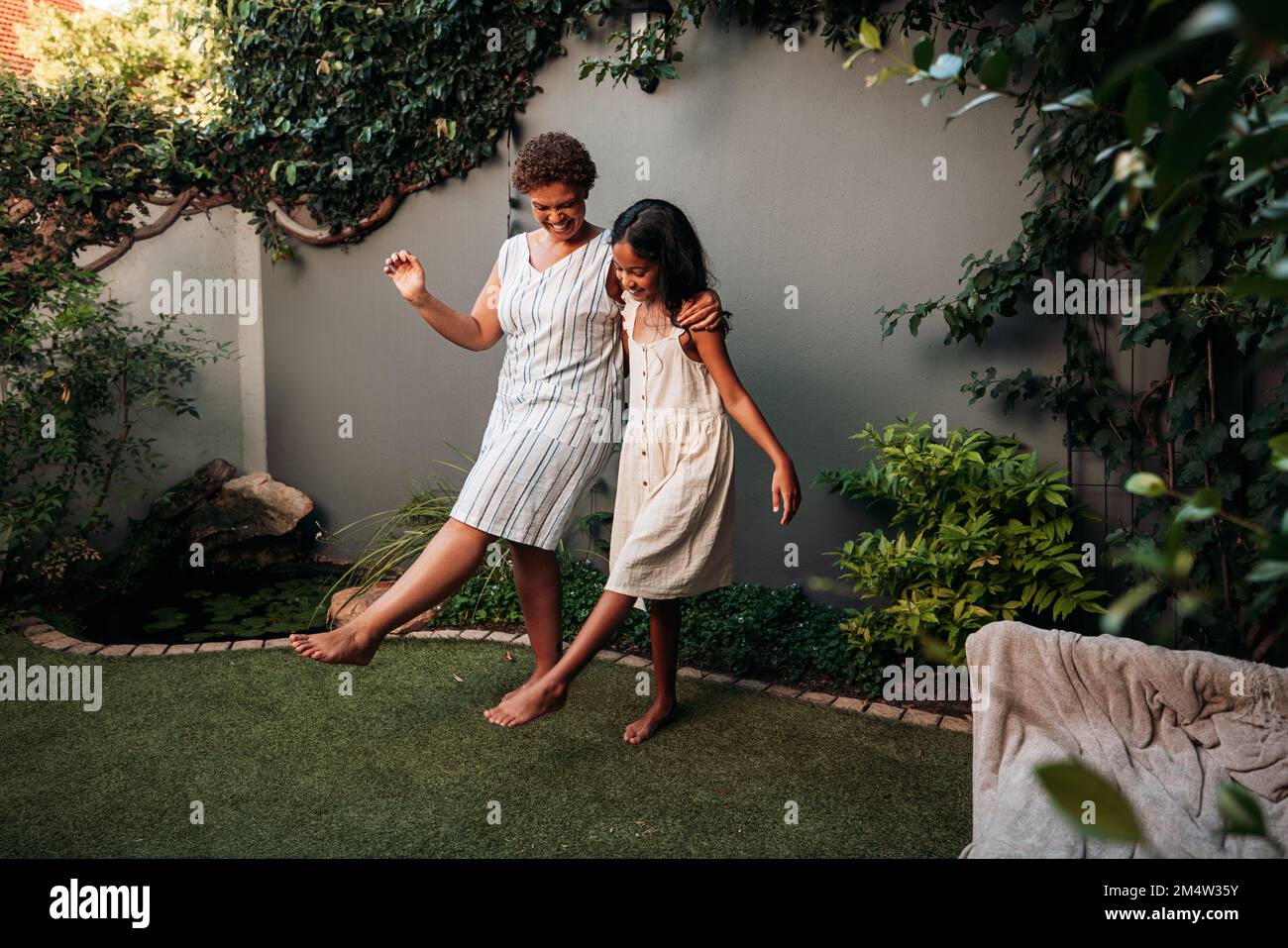 Grandma dancing with her granddaughter in a backyard Stock Photo - Alamy