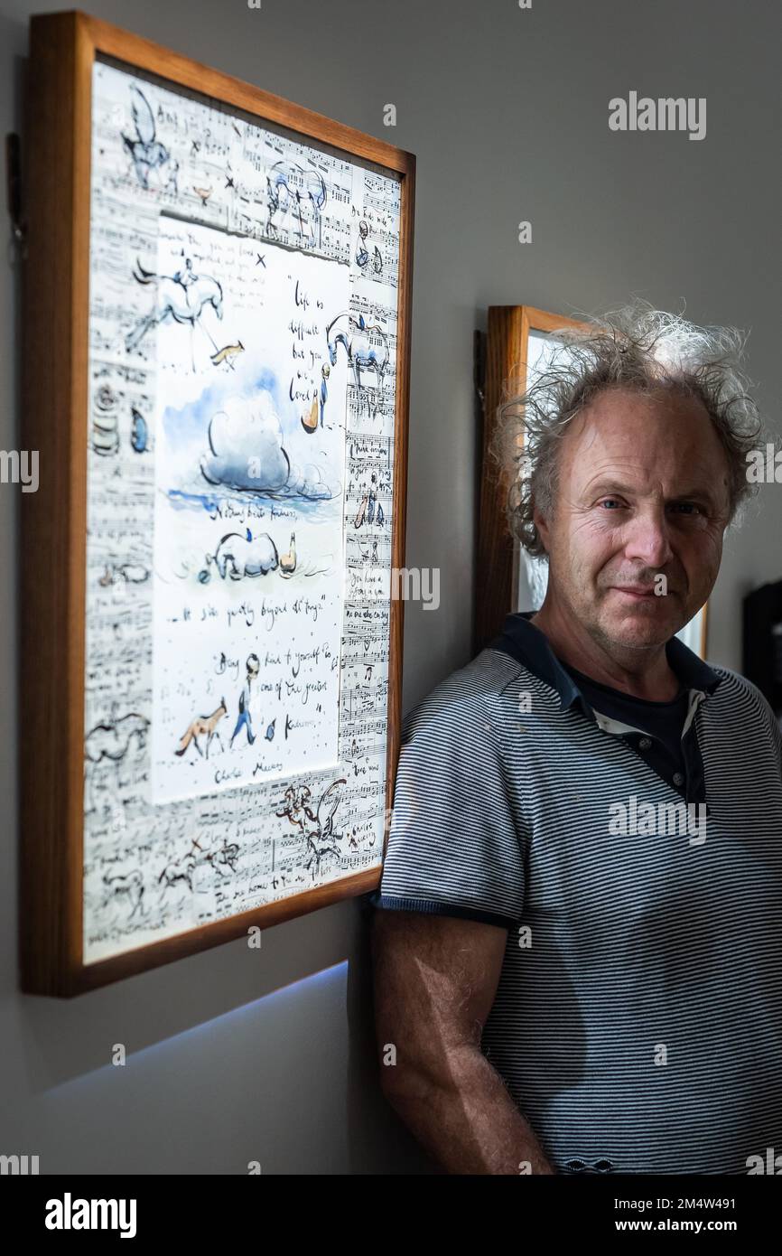 Author and illustrator Charlie Mackesy next to 'You are Loved' a part ...