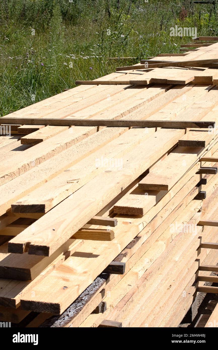 Folded finished boards at the sawmill close up Stock Photo - Alamy