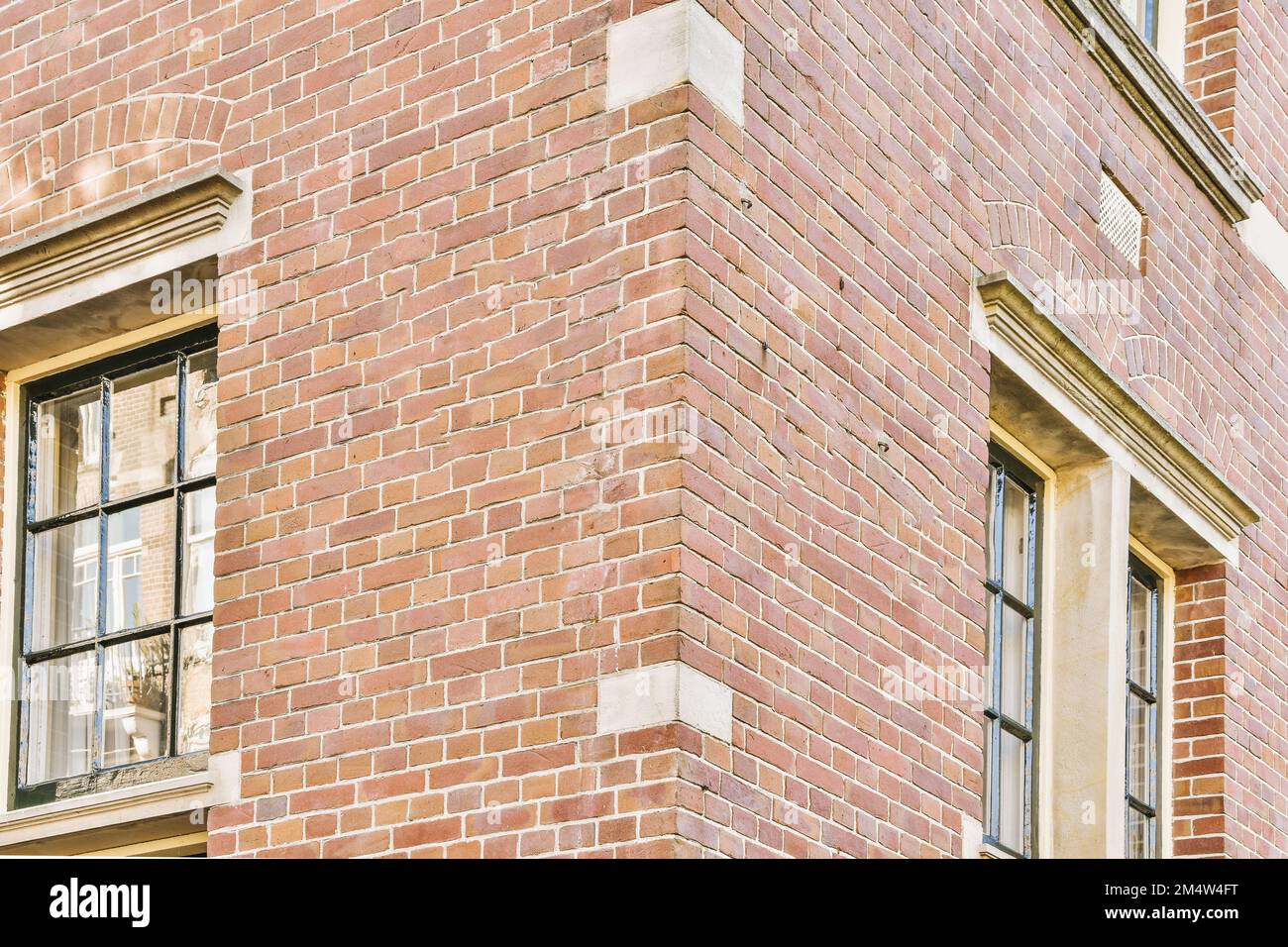 a brick building with a clock on it's side and the window in the middle ...