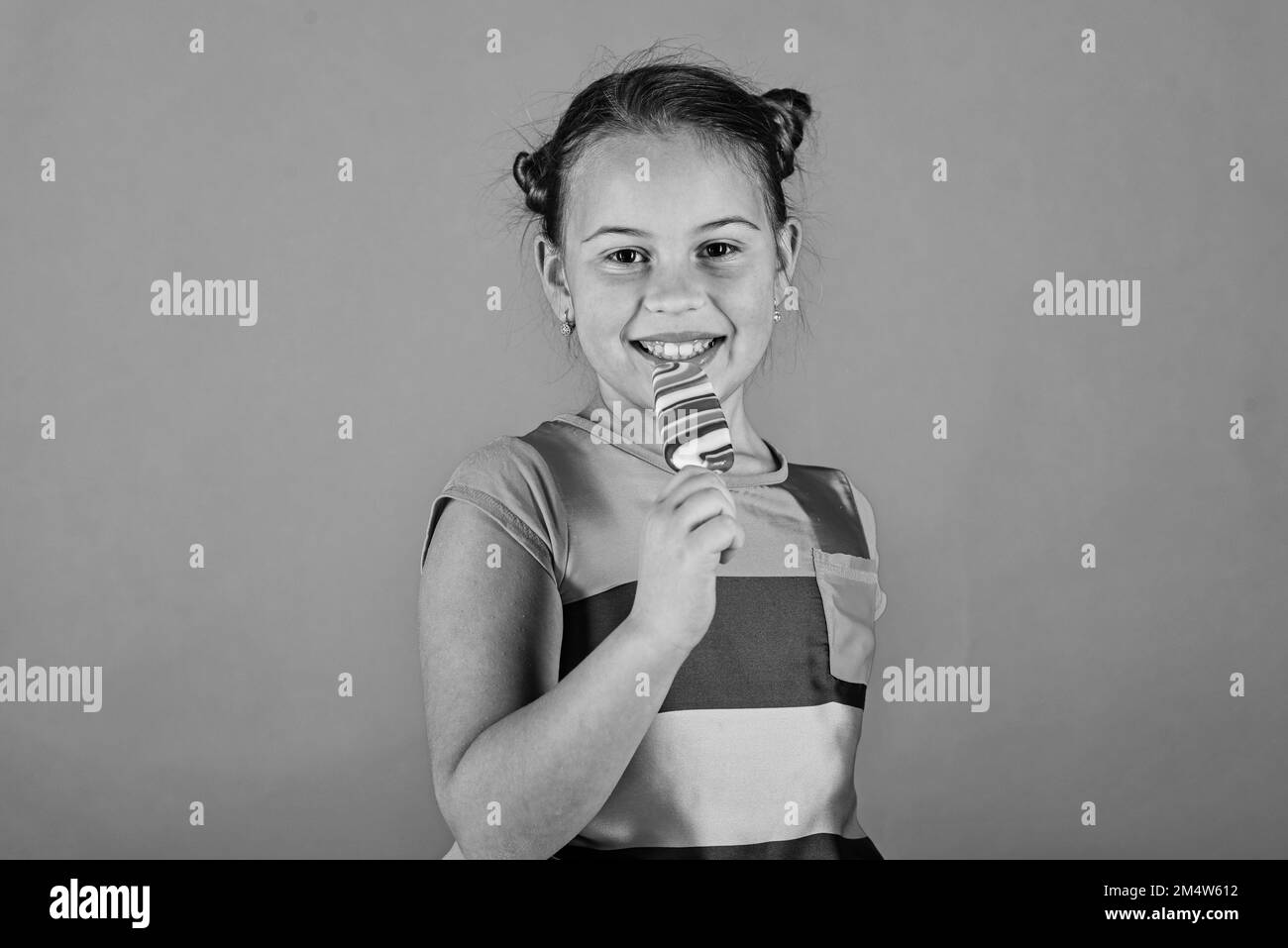 Lady holds long shaped lollipop. Treatment and sweets concept Stock ...