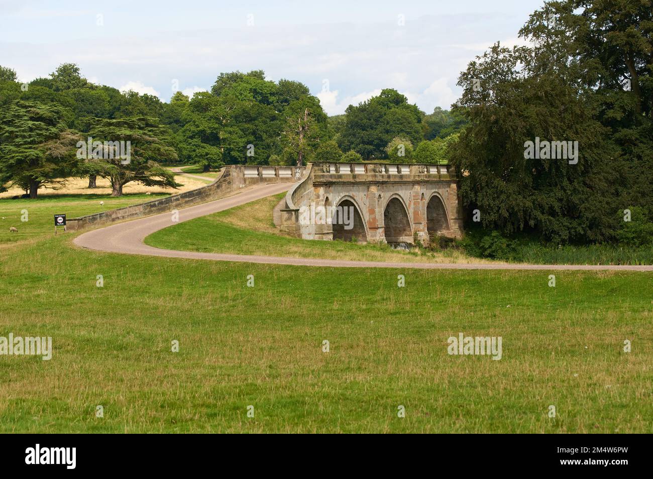 Stone river bridge on a country estate in Derbyshire, UK Stock Photo ...