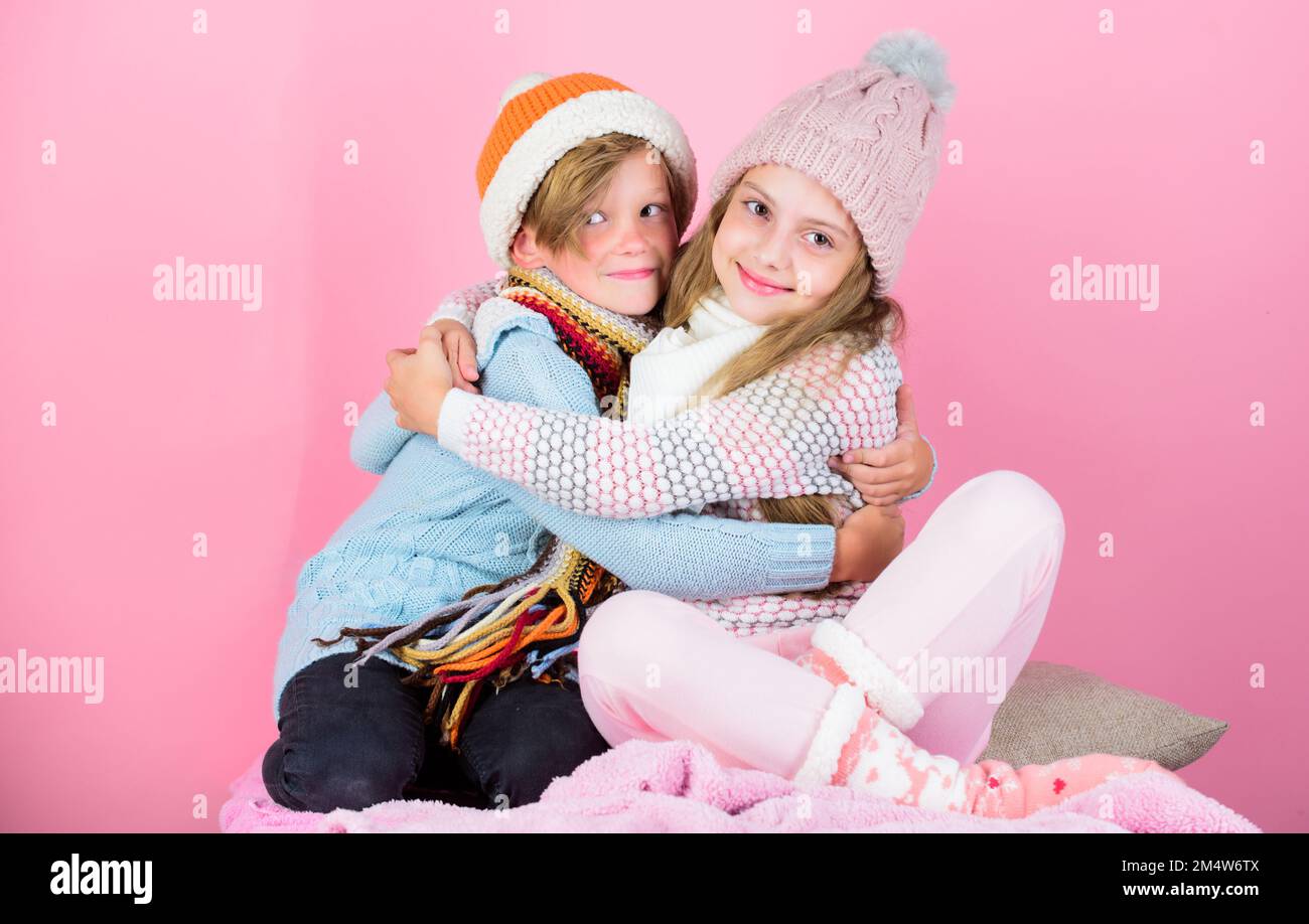 Siblings best friends on pink background. Boy and girl kids hug each ...