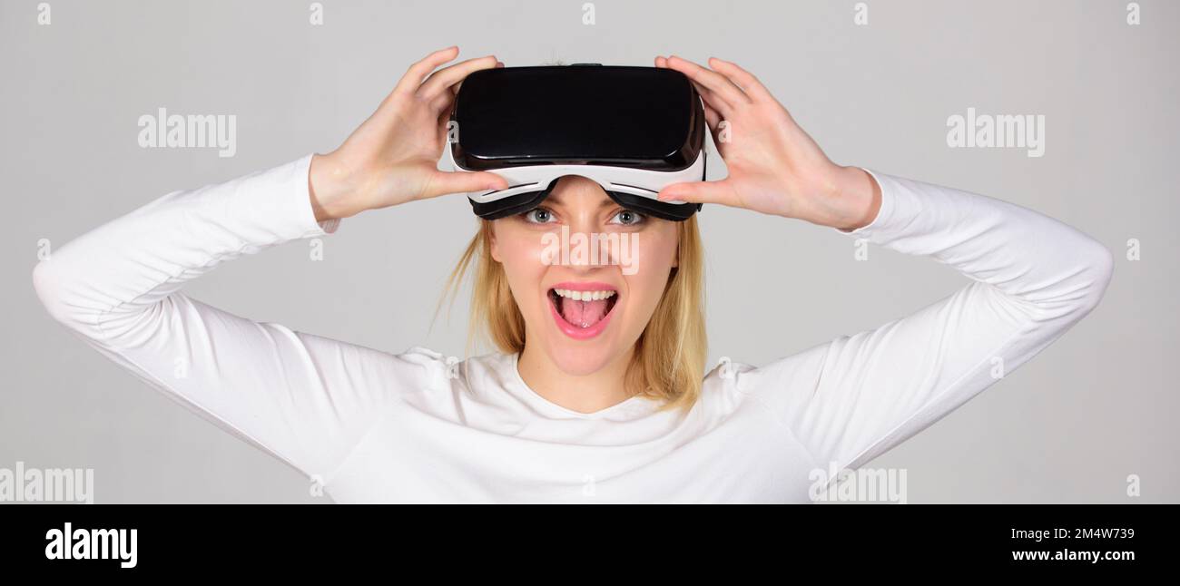 Excited smiling businesswoman wearing virtual reality glasses. Young ...