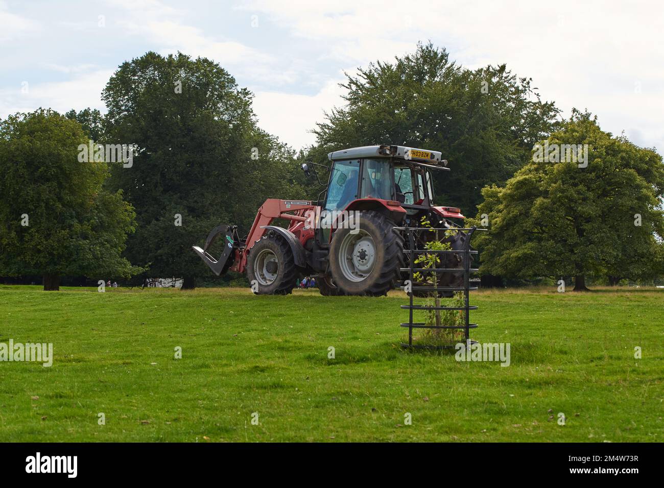Red tractor on a country estate Stock Photo - Alamy