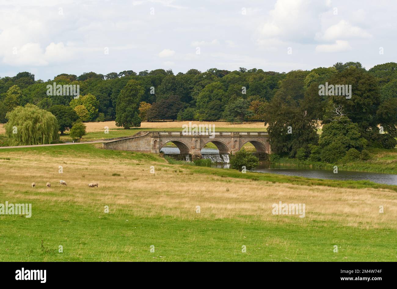 Stone river bridge on a country estate in Derbyshire, UK Stock Photo ...