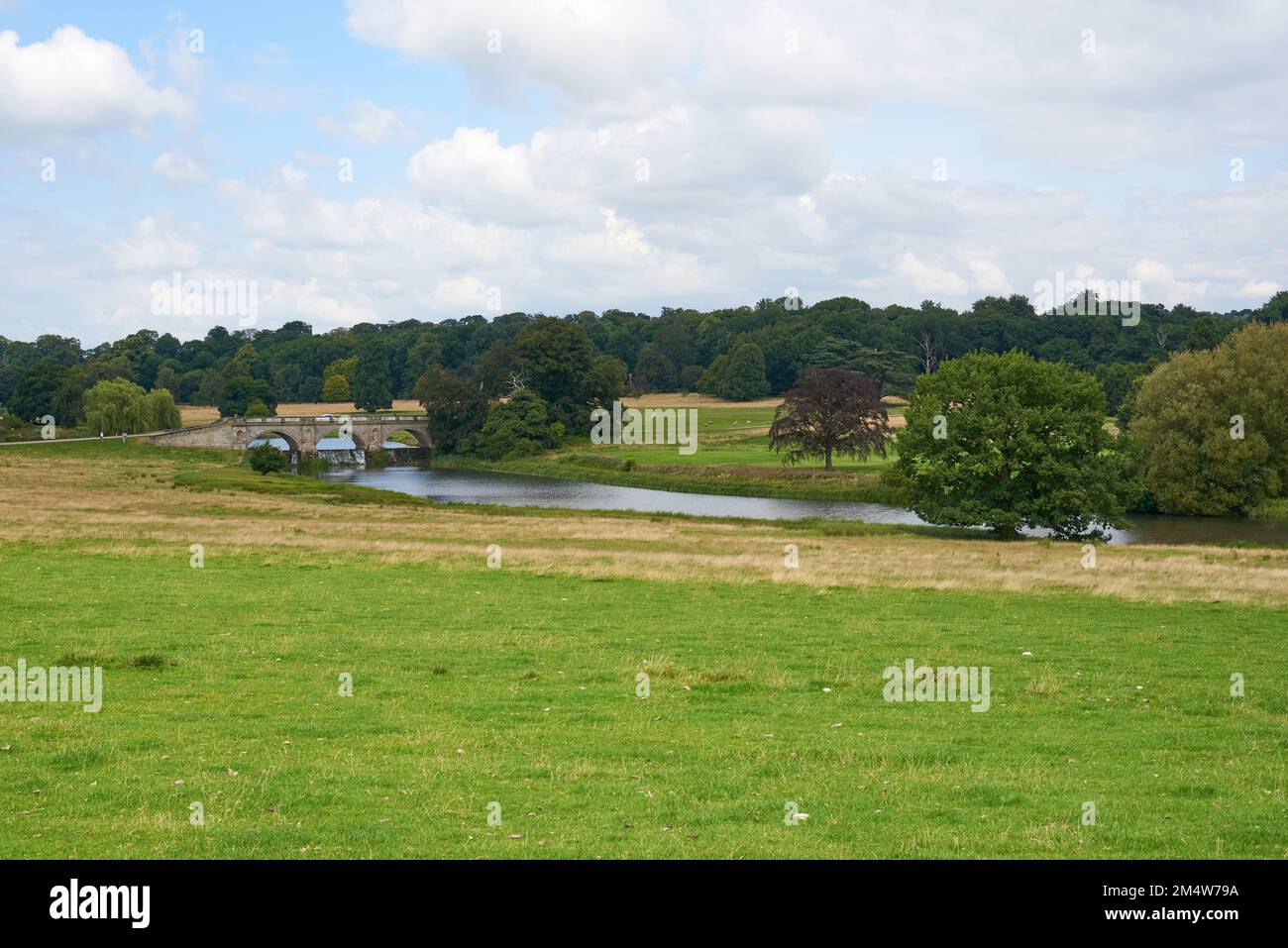 Stone river bridge on a country estate in Derbyshire, UK Stock Photo ...