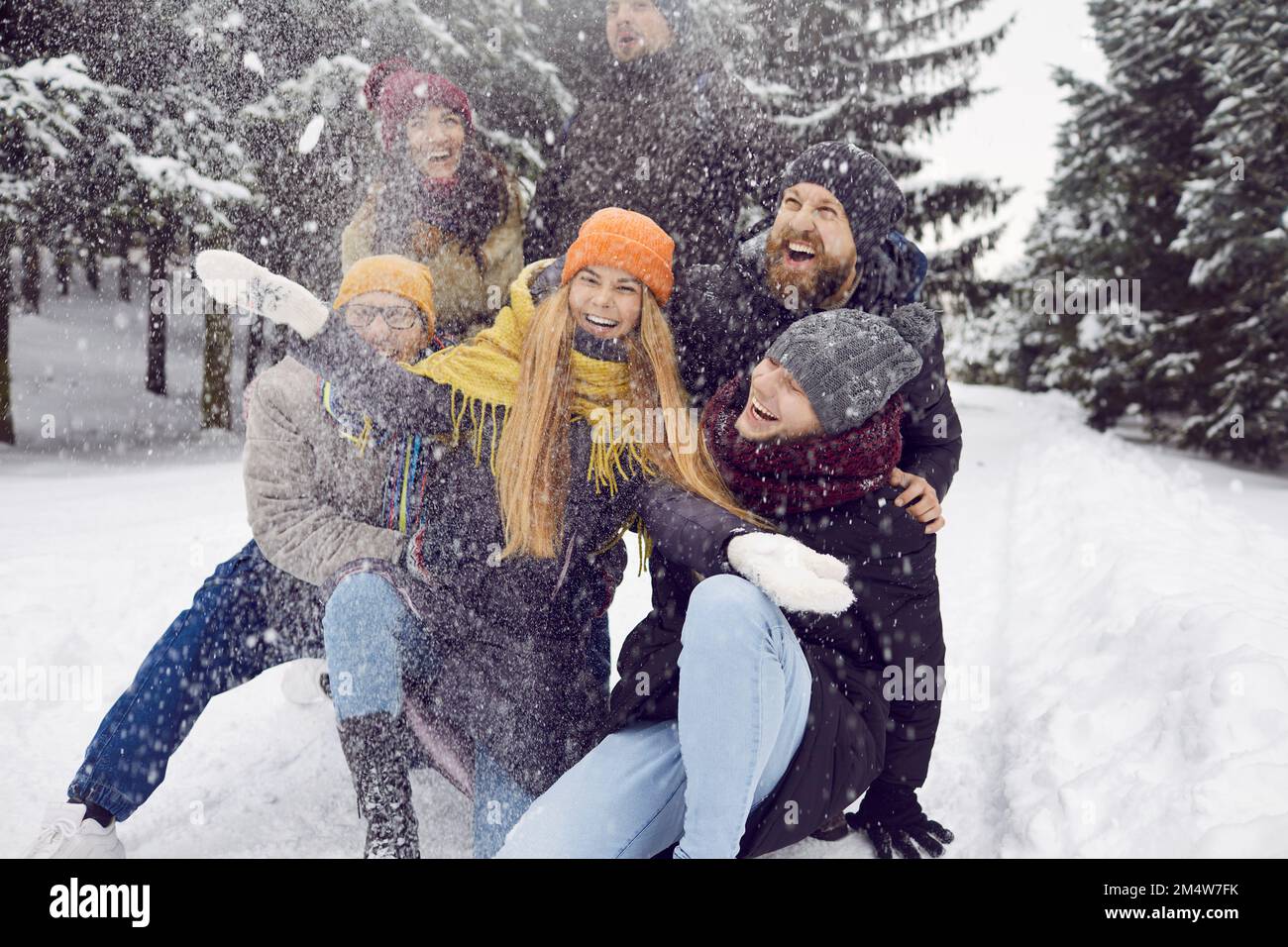 Joyful happy young friends have fun and enjoy cold winter day during ...
