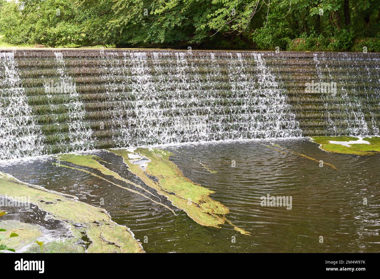 Water flowing over a steep waterfall wall Stock Photo - Alamy