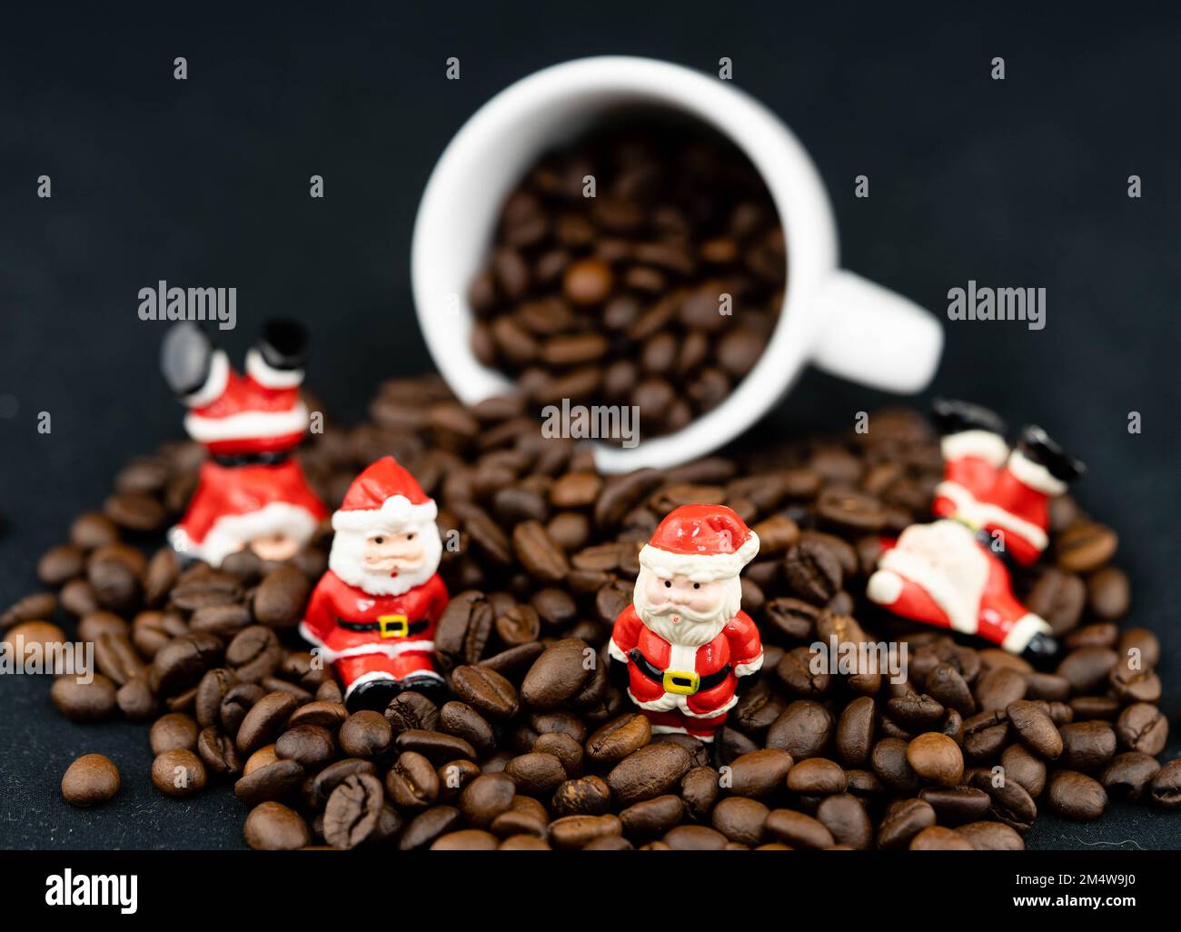 Santa Claus is sitting amid brown roasted coffee beans Stock Photo - Alamy