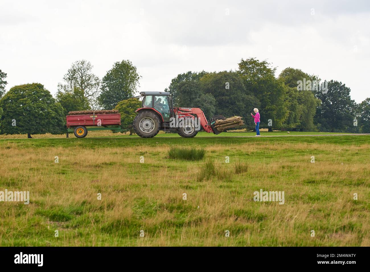 Red farm tractor on a country estate Stock Photo - Alamy