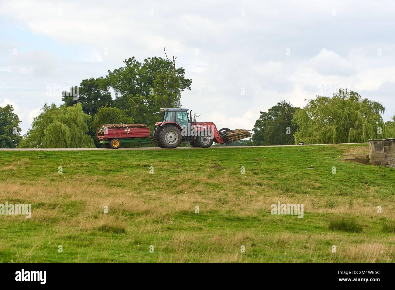 Red farm tractor on a country estate Stock Photo - Alamy