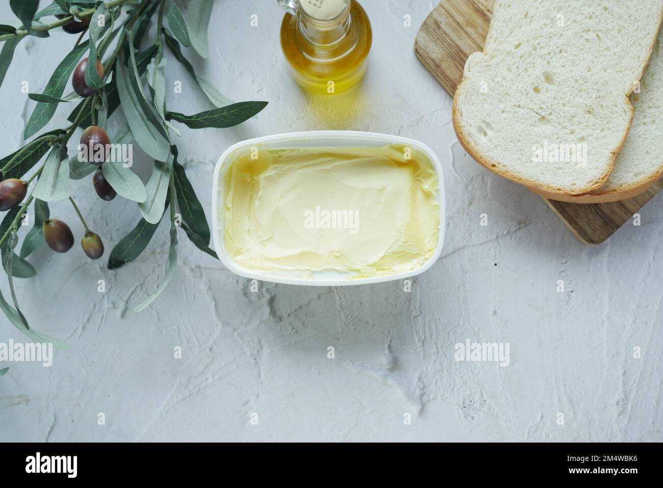fresh olive butter in a container with bread on white background Stock ...