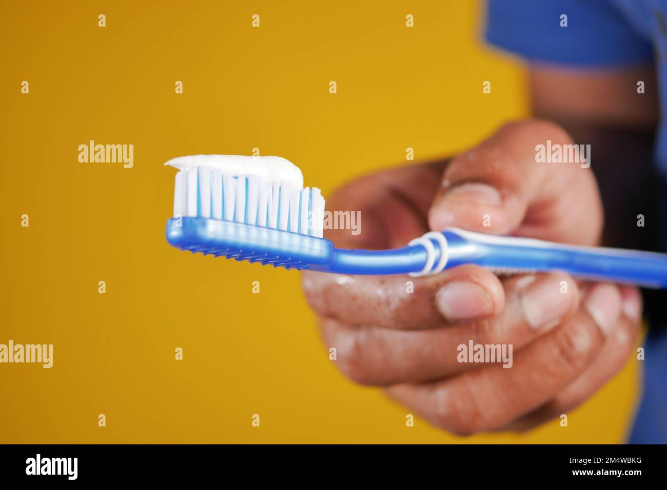 hand holding tooth brush with paste Stock Photo - Alamy