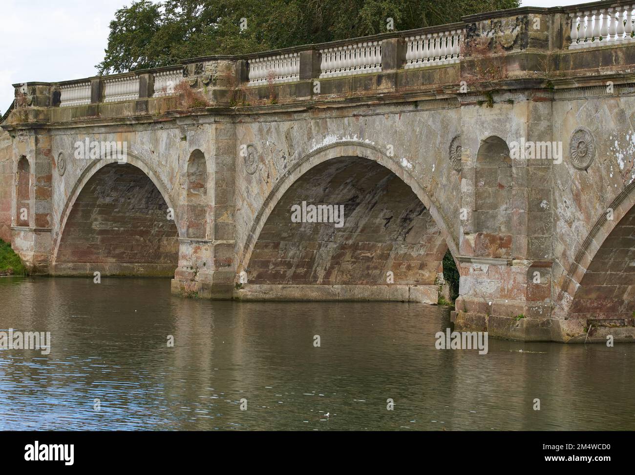 Stone river bridge on a country estate in Derbyshire, UK Stock Photo ...