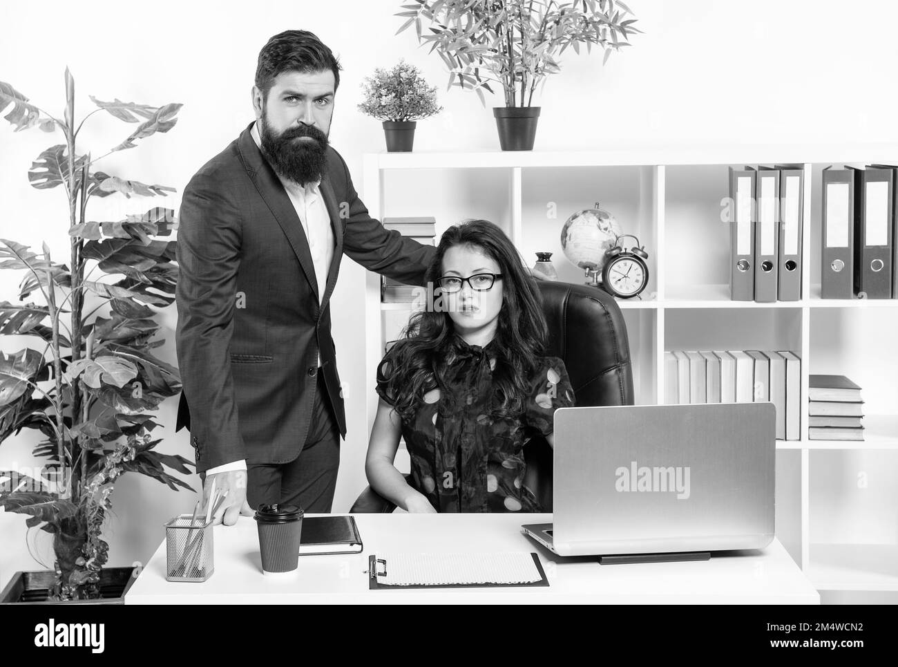 Office employees. Serious employees at work. Professional woman and man ...