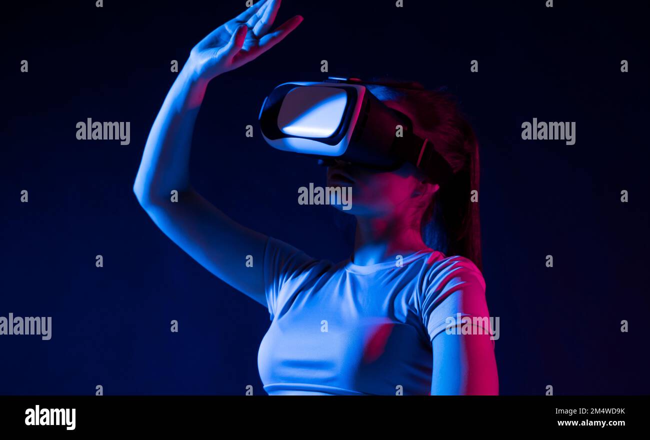 Woman wearing a VR headset and interacting with virtual reality interfaces. Technology, Video ...