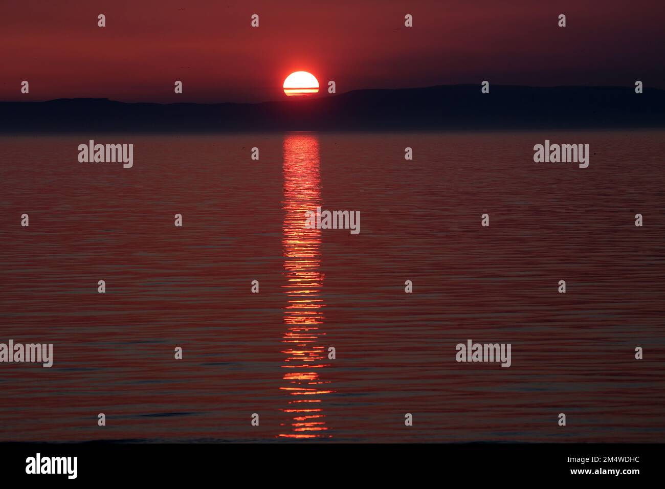 The Isle of Arran, Scotland, UK.Sunset over the island from the beach ...