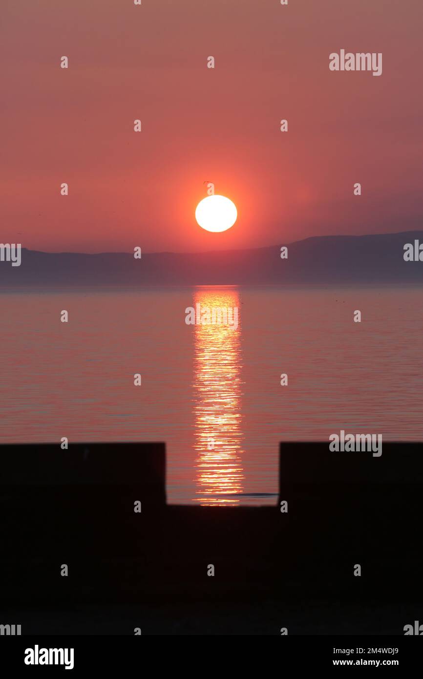 The Isle of Arran, Scotland, UK.Sunset over the island from the beach ...