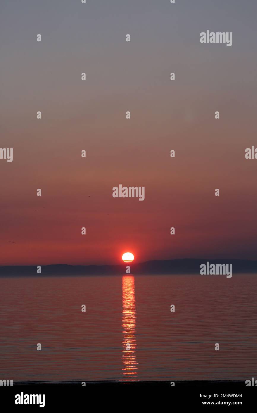 The Isle of Arran, Scotland, UK.Sunset over the island from the beach ...