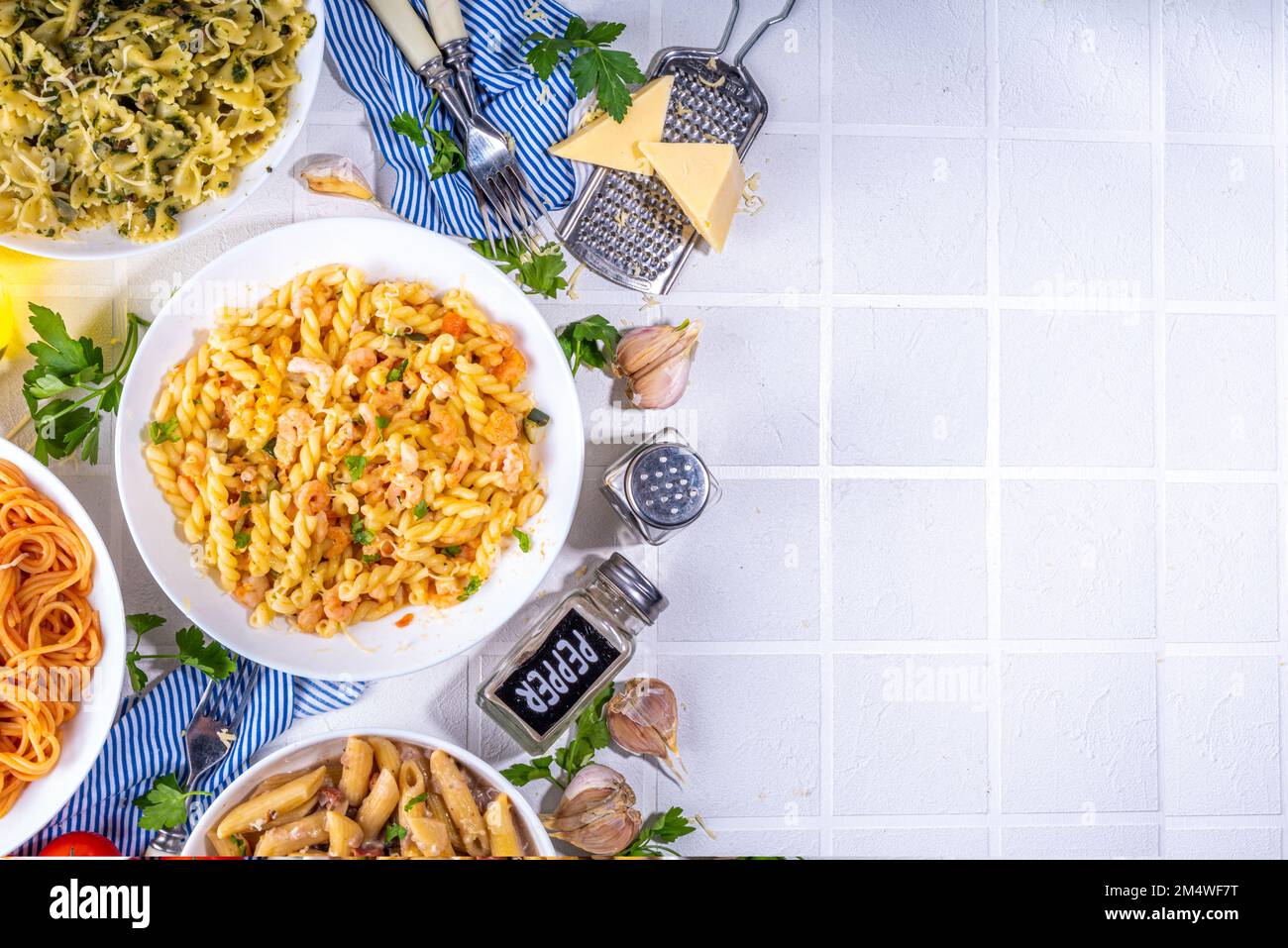 Set of pasta with different sauces on white tiled background. Spaghetti ...