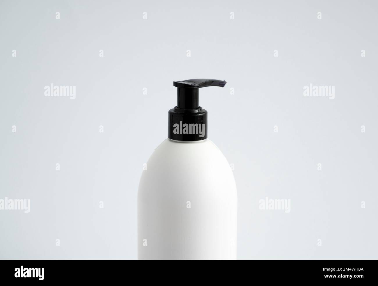 White unbranded bottle with a black dispenser isolated on white ...