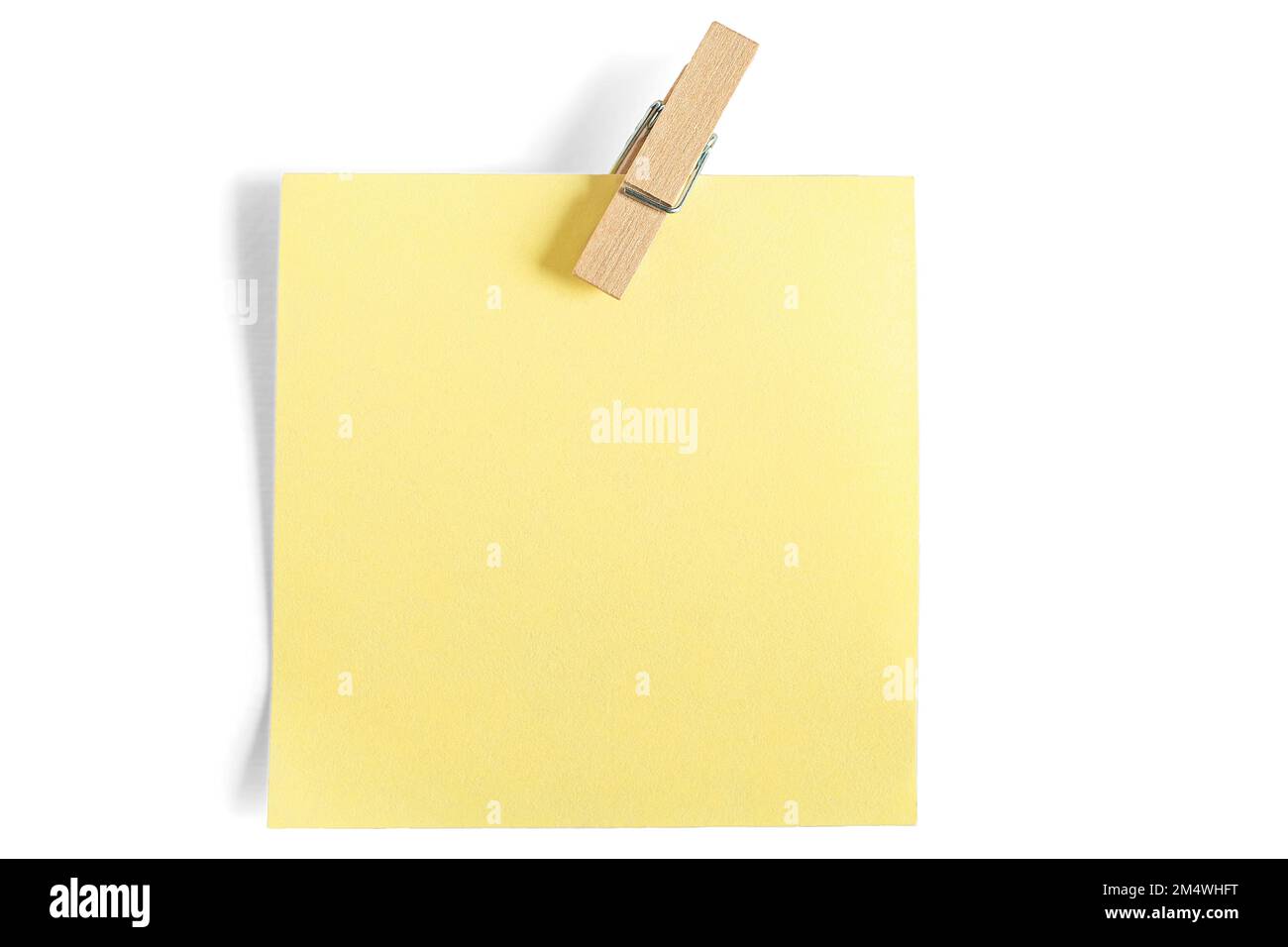 Wooden clothespin and yellow paper notes isolated on white background ...