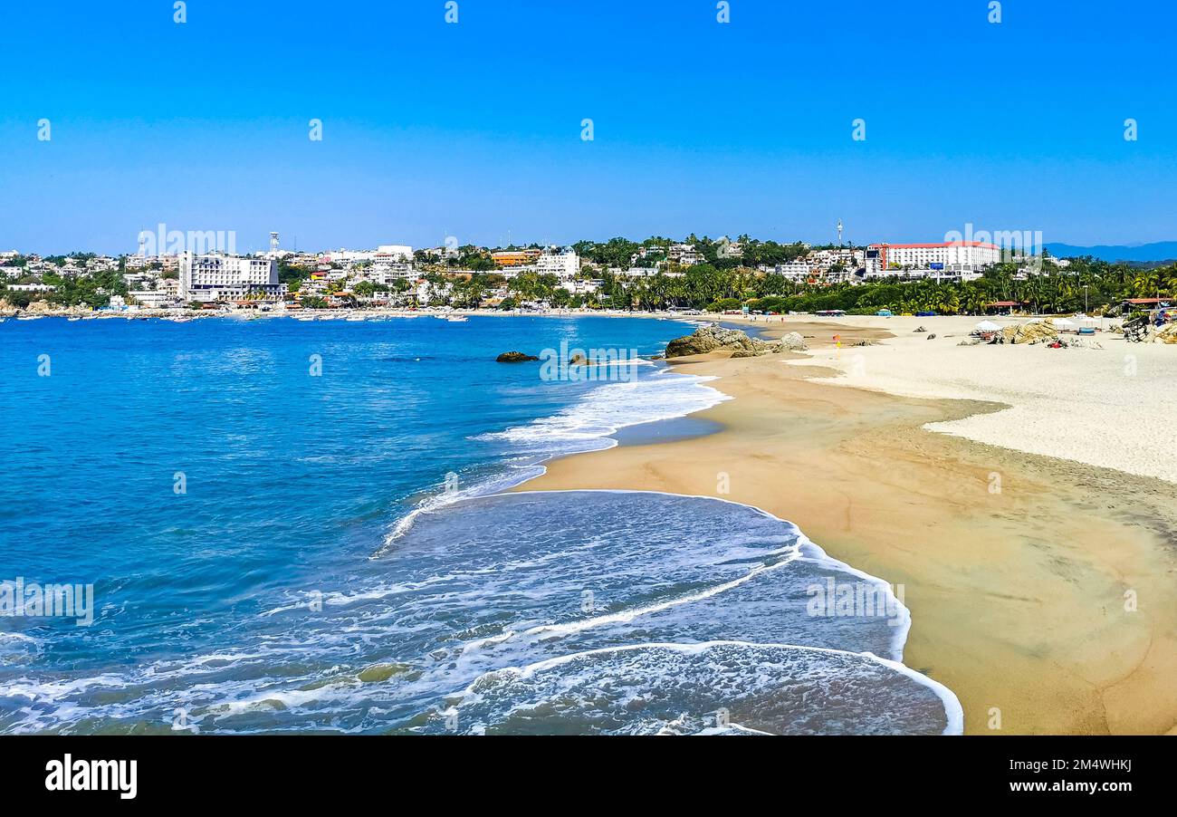 Beach sand blue water rocks cliffs and huge big surfer waves on the ...
