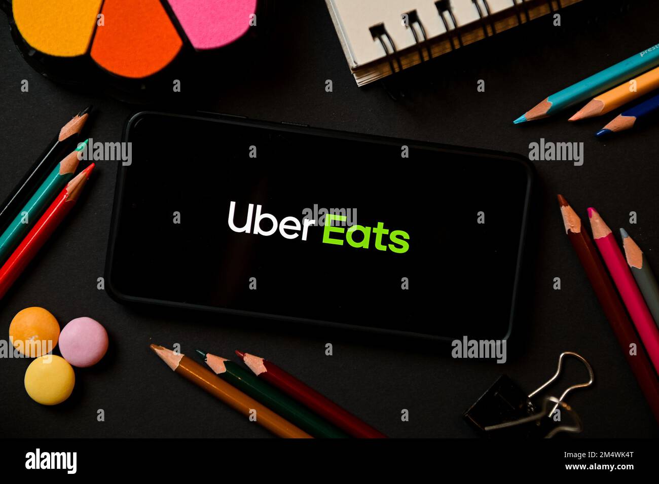 In this photo illustration a Uber Eats logo seen displayed on a ...