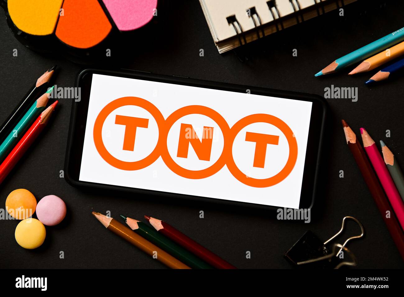 In this photo illustration a TNT logo seen displayed on a smartphone ...