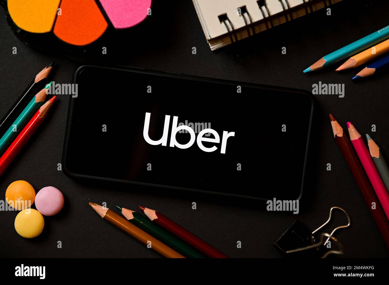 In this photo illustration, the Uber logo seen displayed on a ...