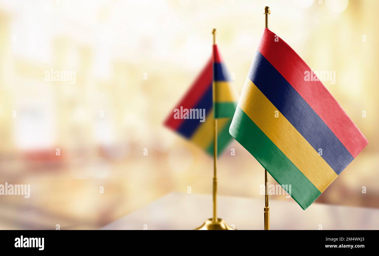 Small flags of the Mauritius on an abstract blurry background Stock ...