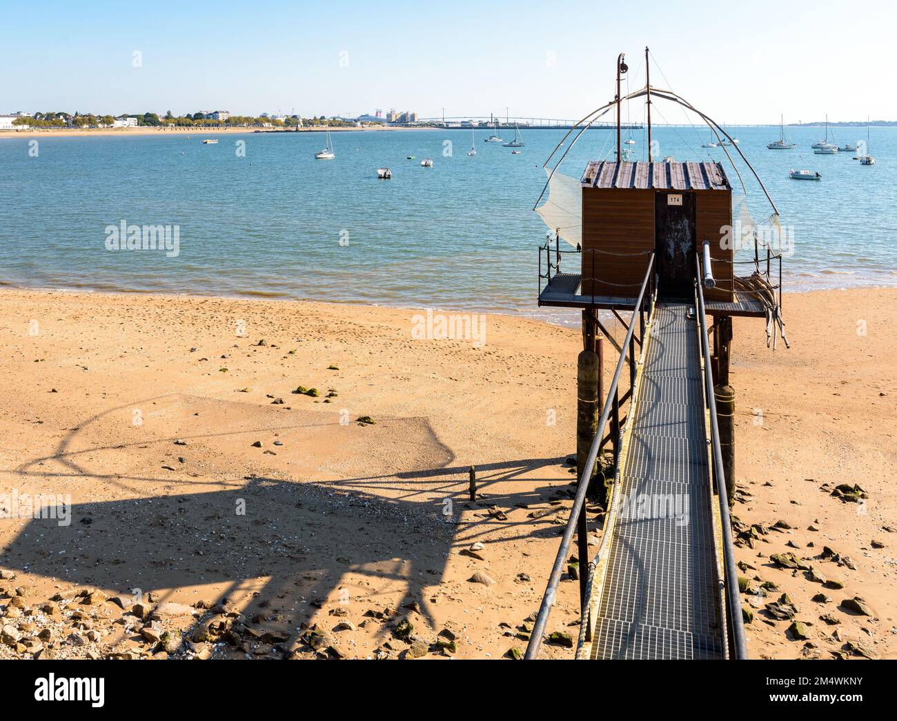 A wooden fishing cabin with a large square lift net called "carrelet ...