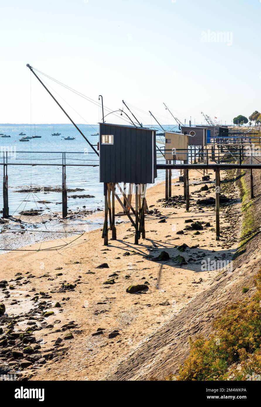 Fishing cabins with a large square lift net called "carrelet" lined up ...