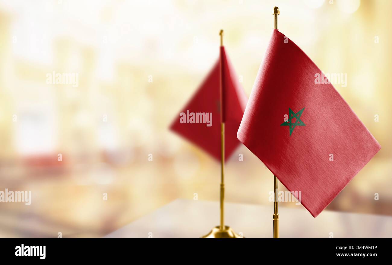 Small flags of the Morocco on an abstract blurry background Stock Photo ...