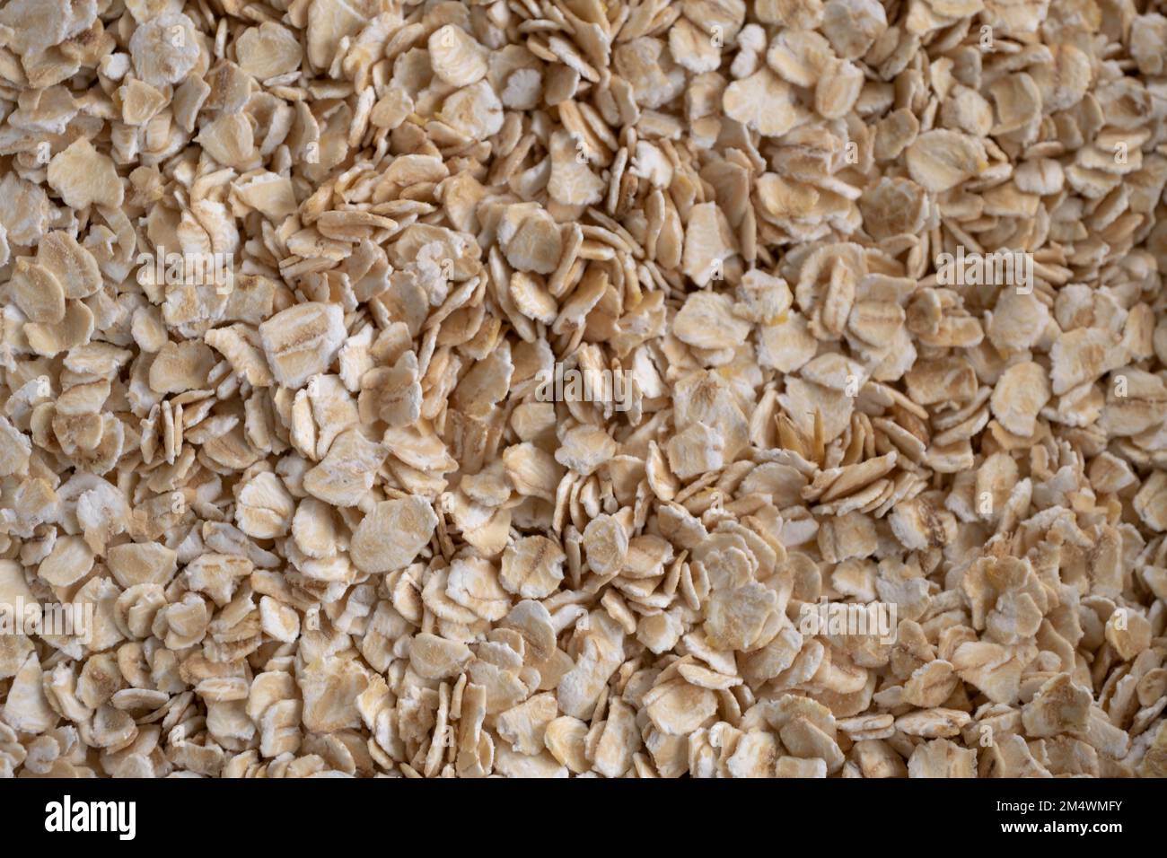 Oatmeal background. Dried, peeled and cut oat flakes, a healthy ...