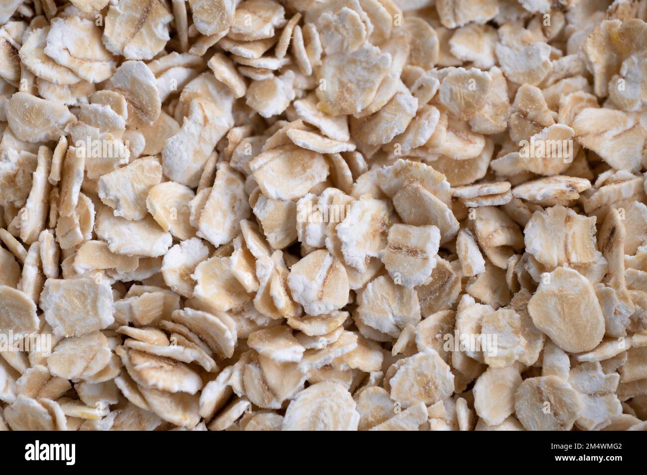 Oatmeal background. Dried, peeled and cut oat flakes, a healthy ...