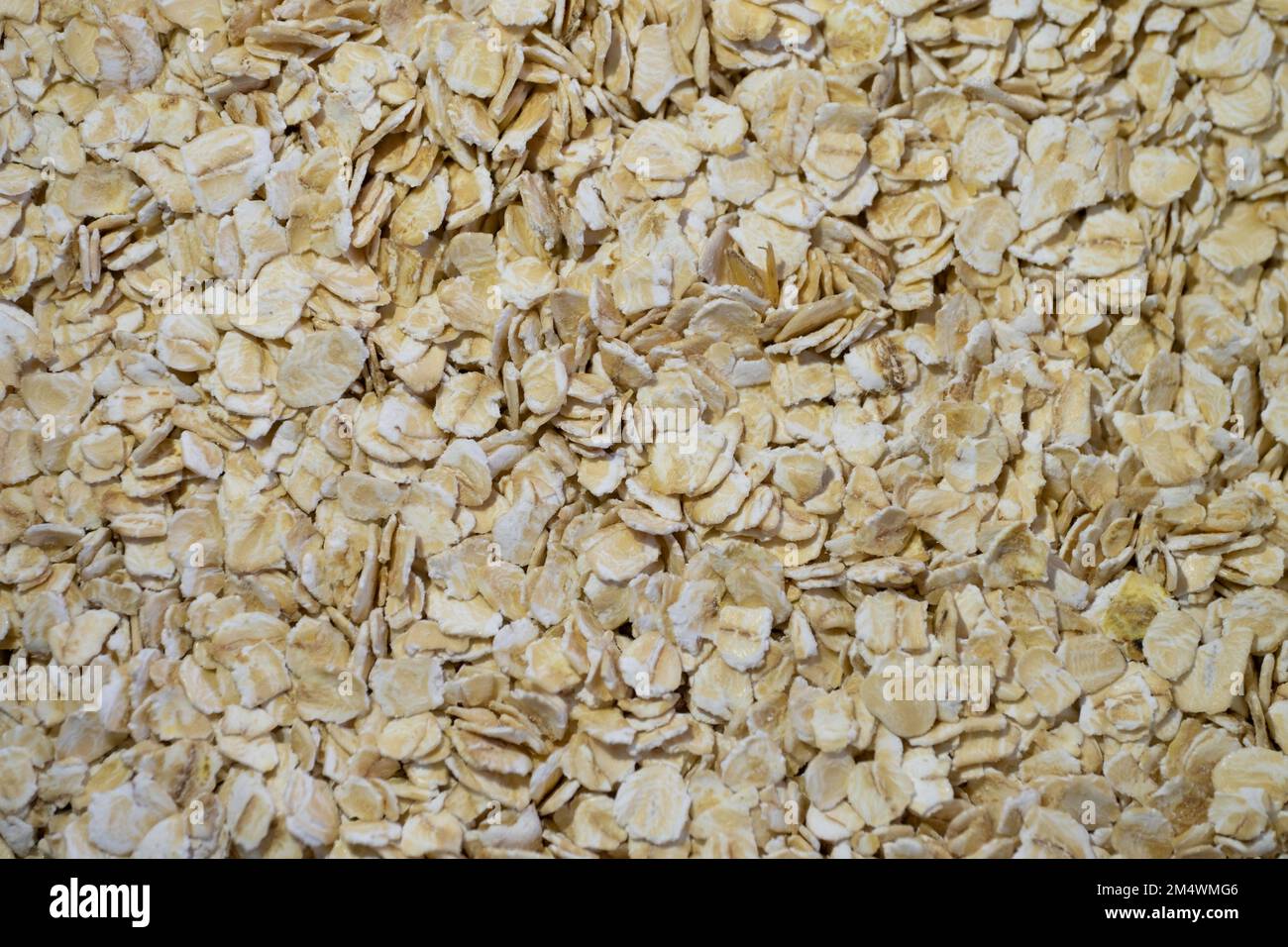 Oatmeal background. Dried, peeled and cut oat flakes, a healthy ...