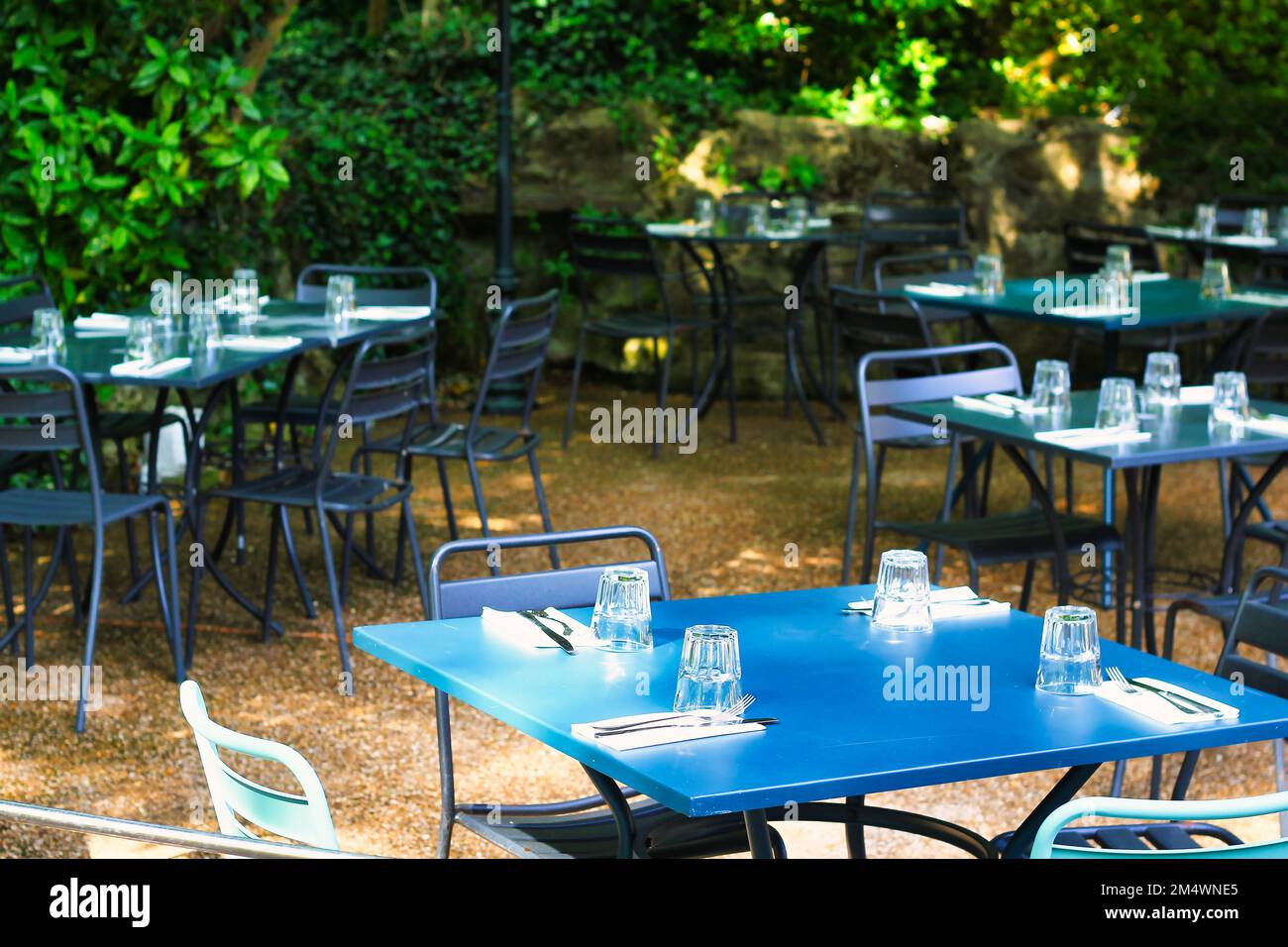 Outdoor patio restaurant tables served for lunch in the middle of the ...