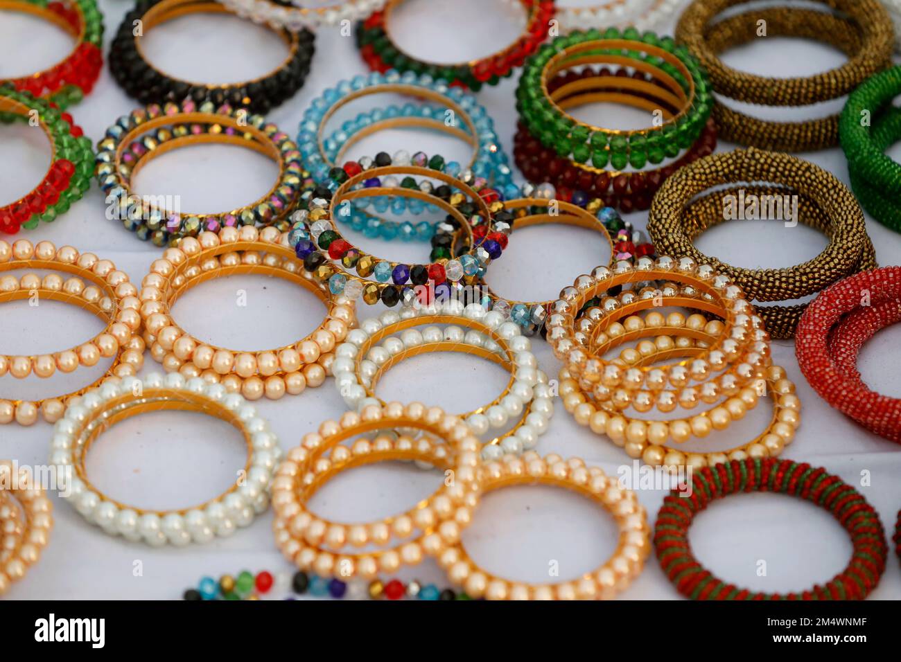 Dhaka, Bangladesh - December 16, 2022: Street hawker display their pearl necklace for sell at ...