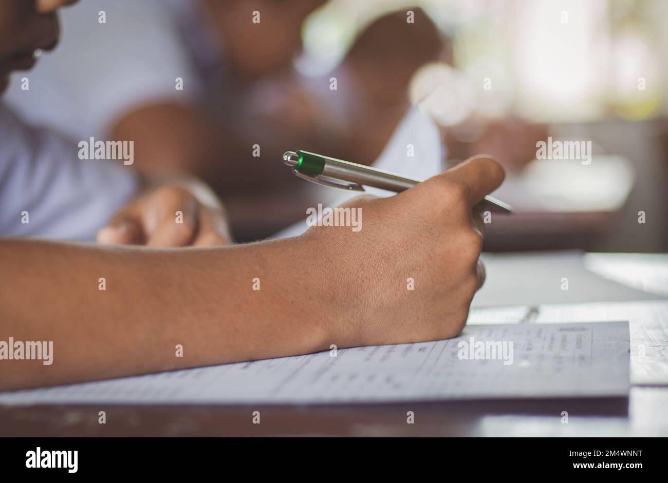 Students reading exam answer sheets exercises in classroom of school ...