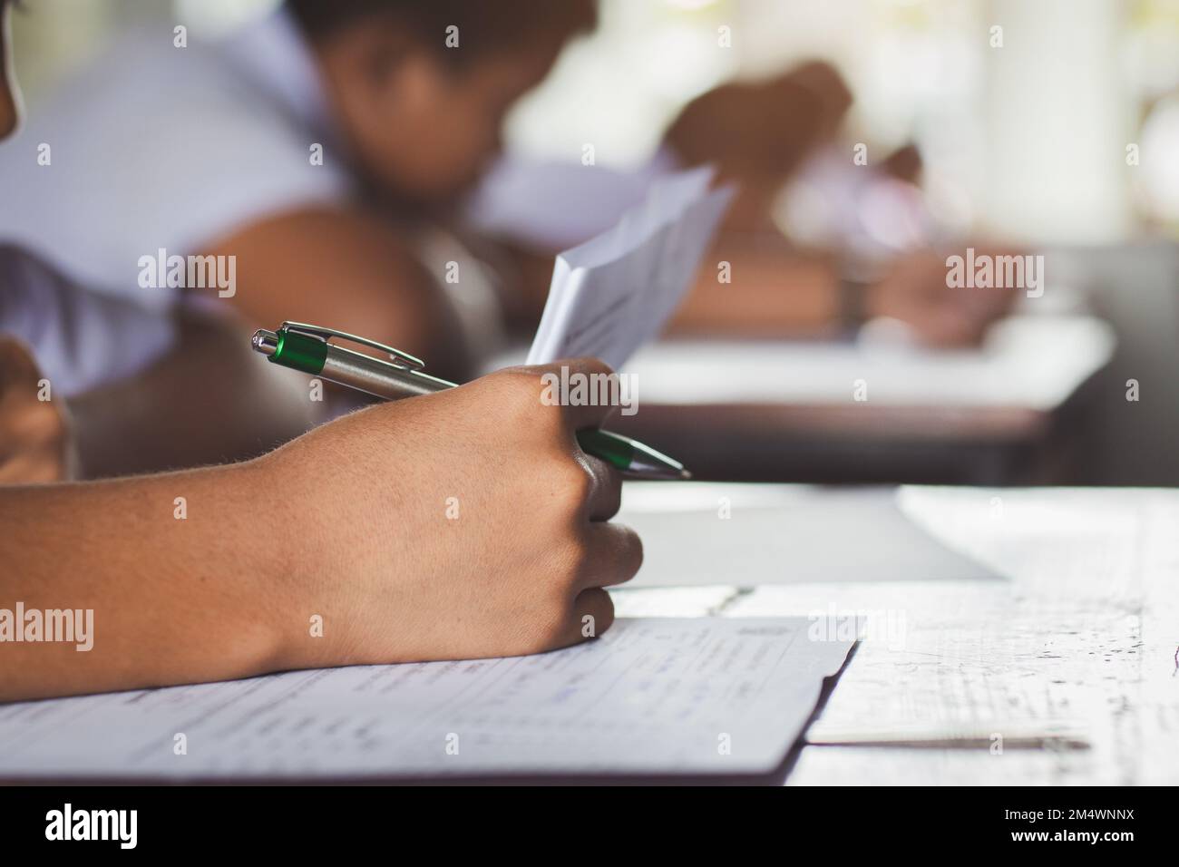 Students reading exam answer sheets exercises in classroom of school ...
